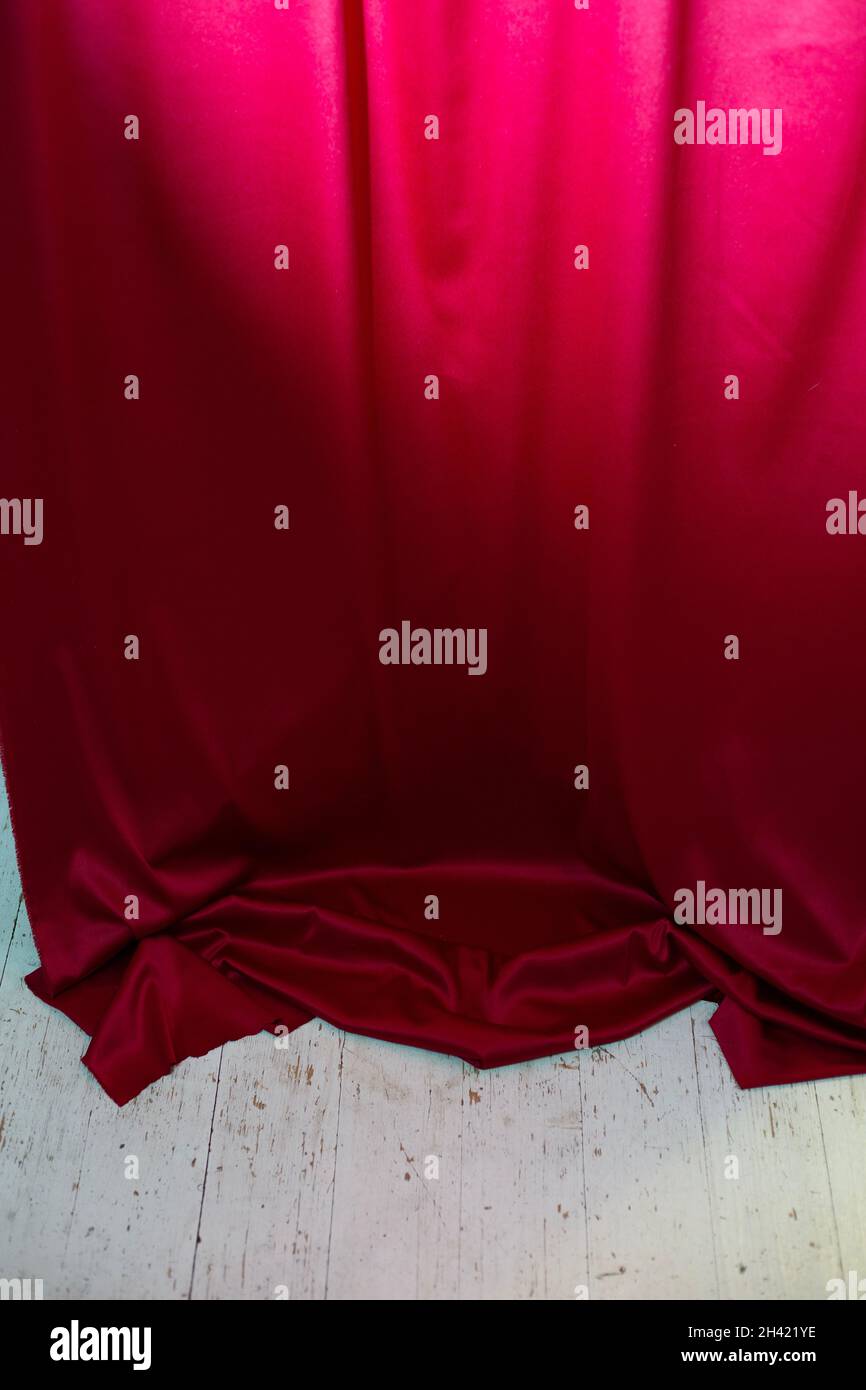 Red fabric in the light and white floor Stock Photo - Alamy