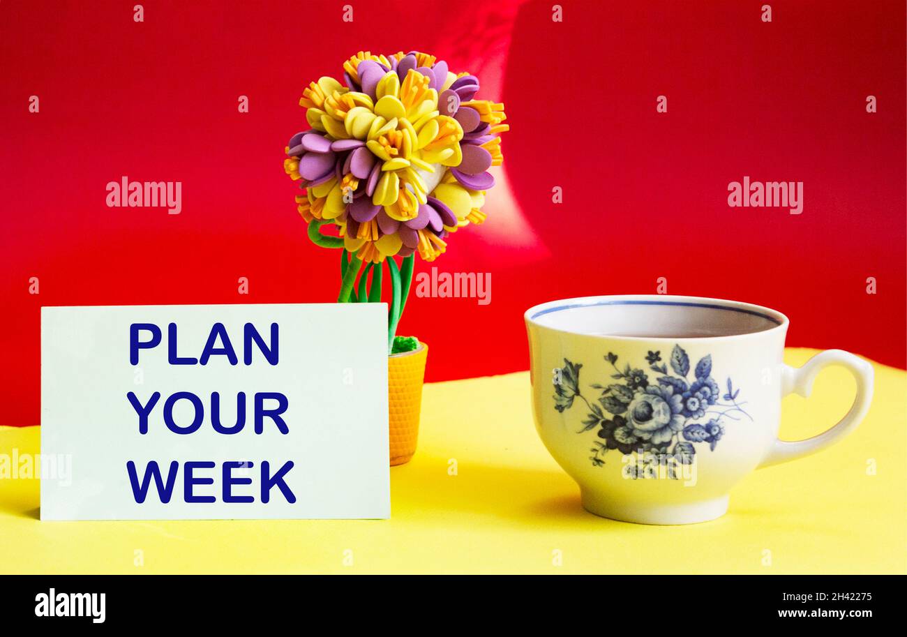 Plan your week highlighted in red on a sticky note posted against a ...