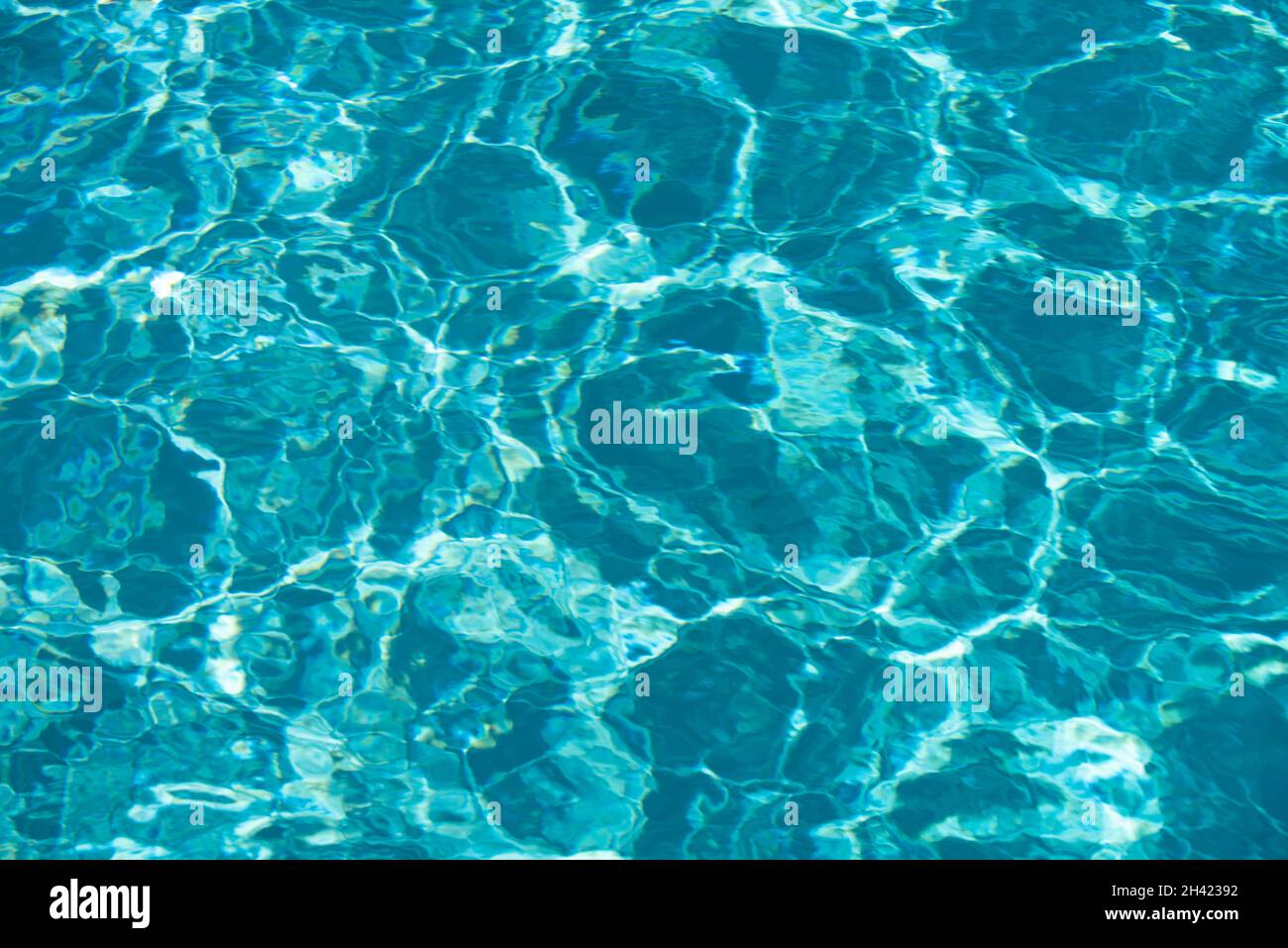 Abstract ripple wave and clear turquoise water surface in swimming pool ...