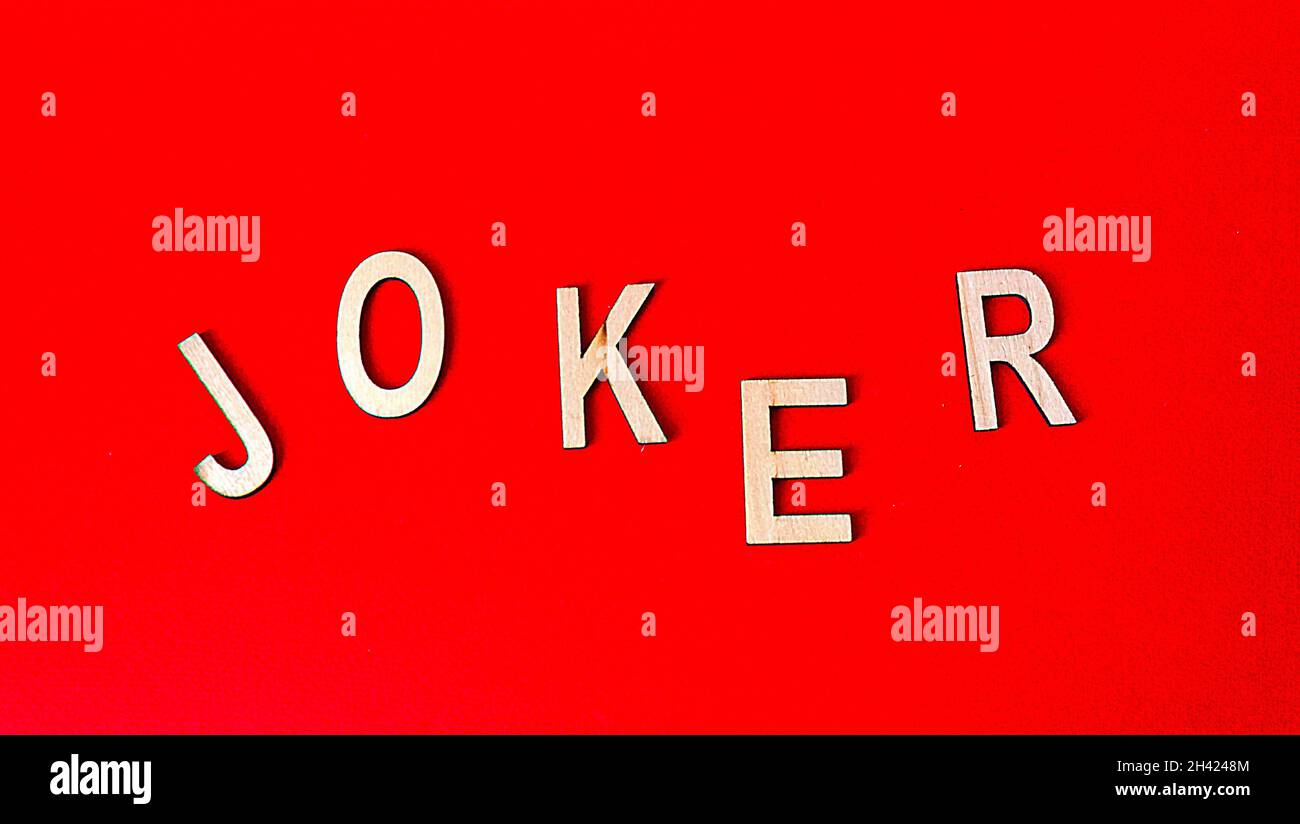 English word Joker in capital wooden letters on red background Stock ...