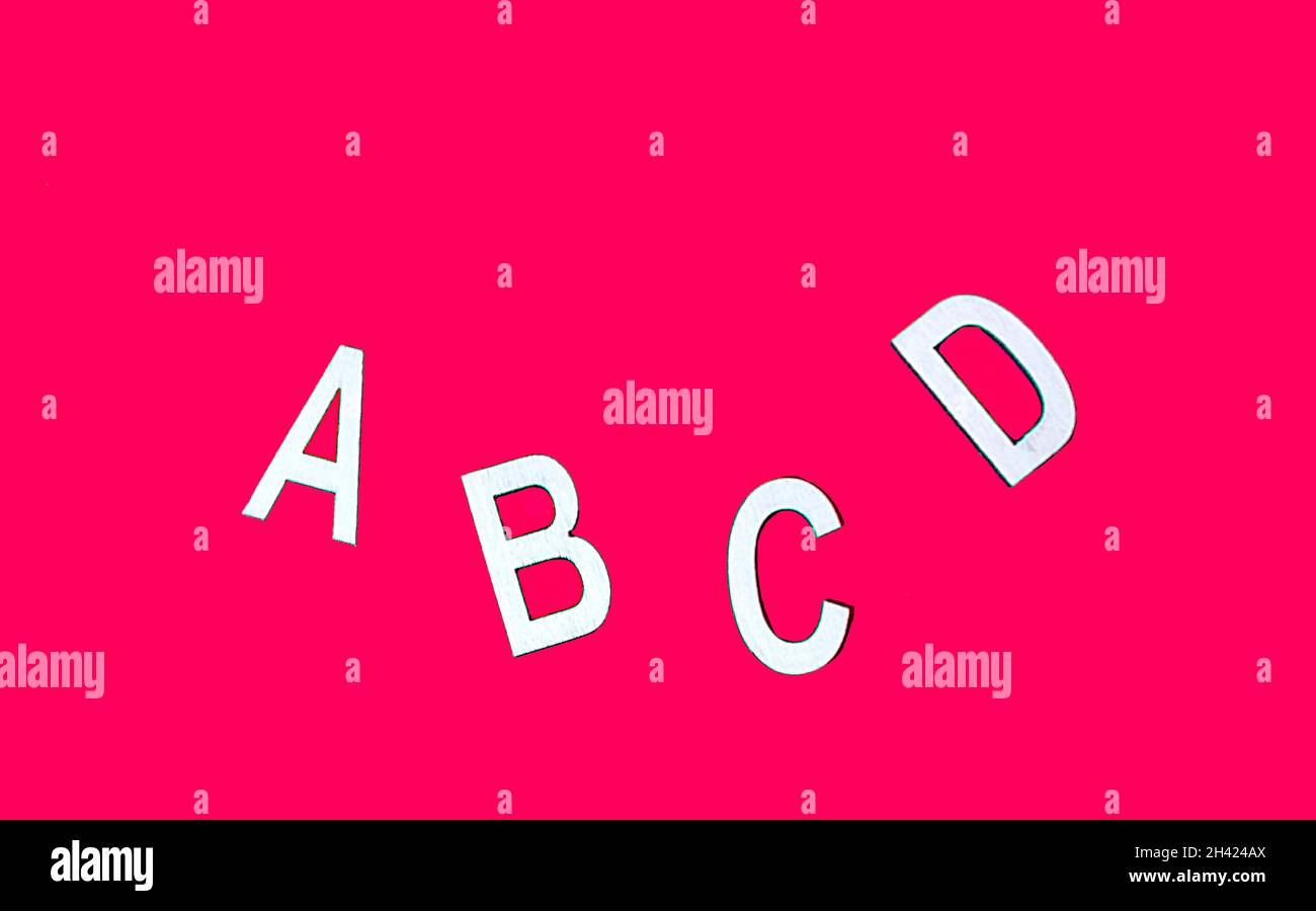 Wooden letters of the alphabet ABCD on a red background. The beginning ...