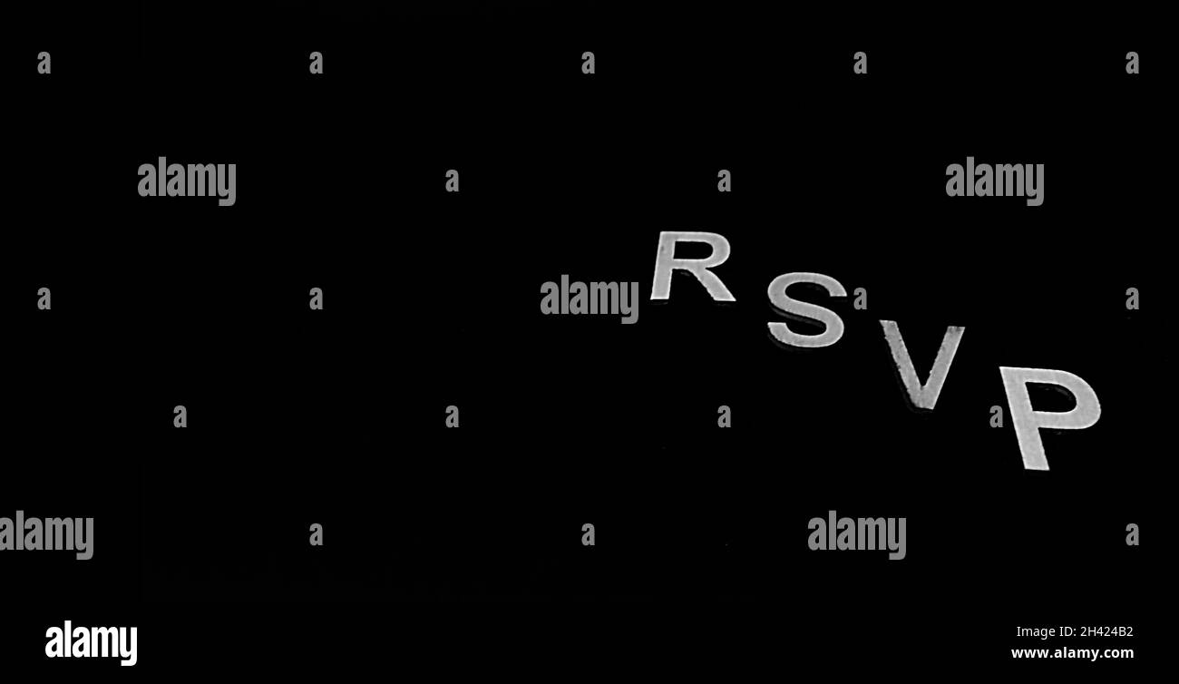 Wooden letters RSVP on a black background. There is a place for text ...