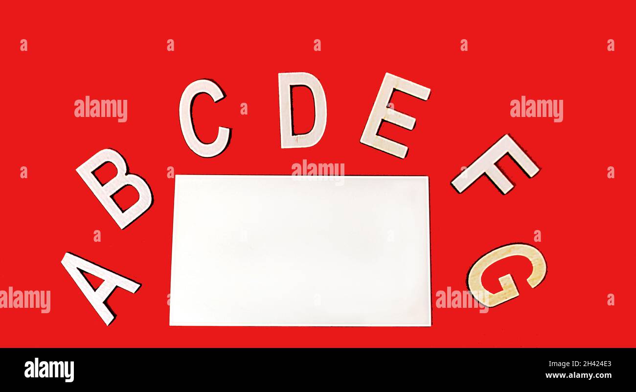 Alphabet, letters with wood texture on a red background, next to a ...
