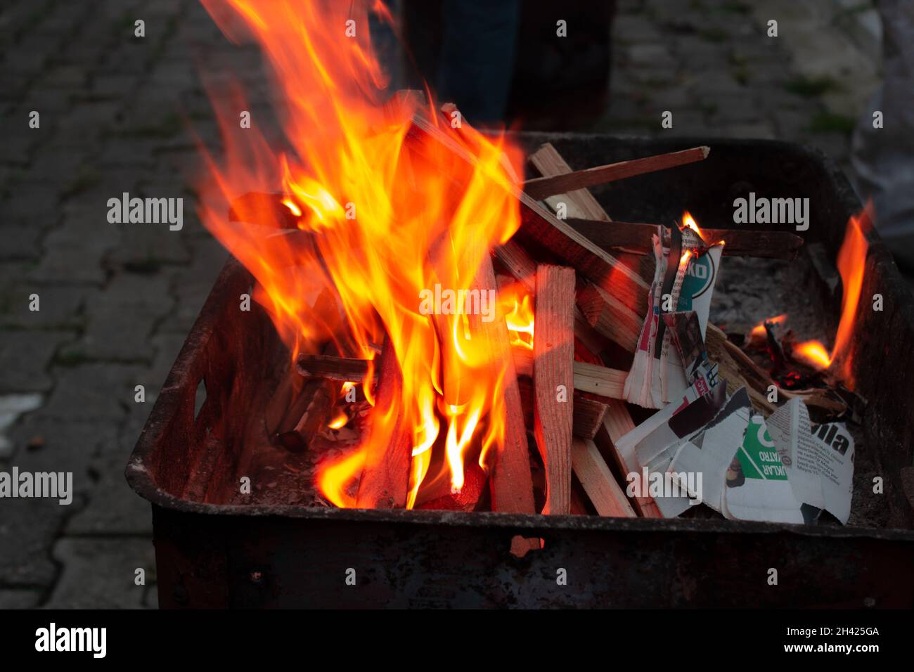 Stacked wooden pieces in a grill burning in orange fire. Preparation ...