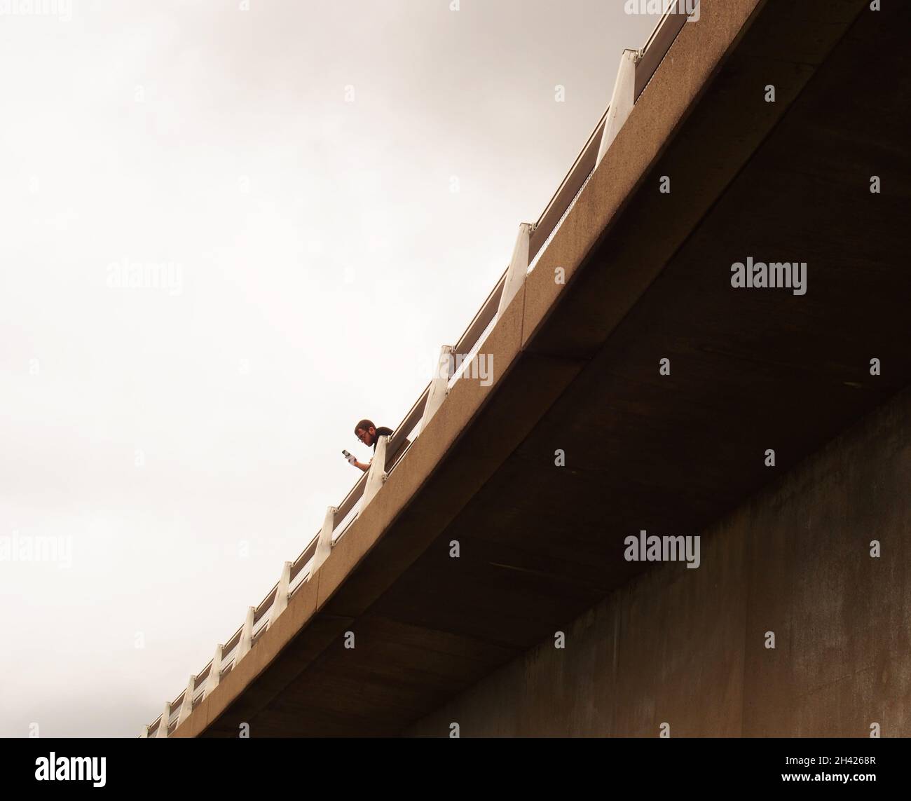 Leaning on bridge railing hi-res stock photography and images - Alamy