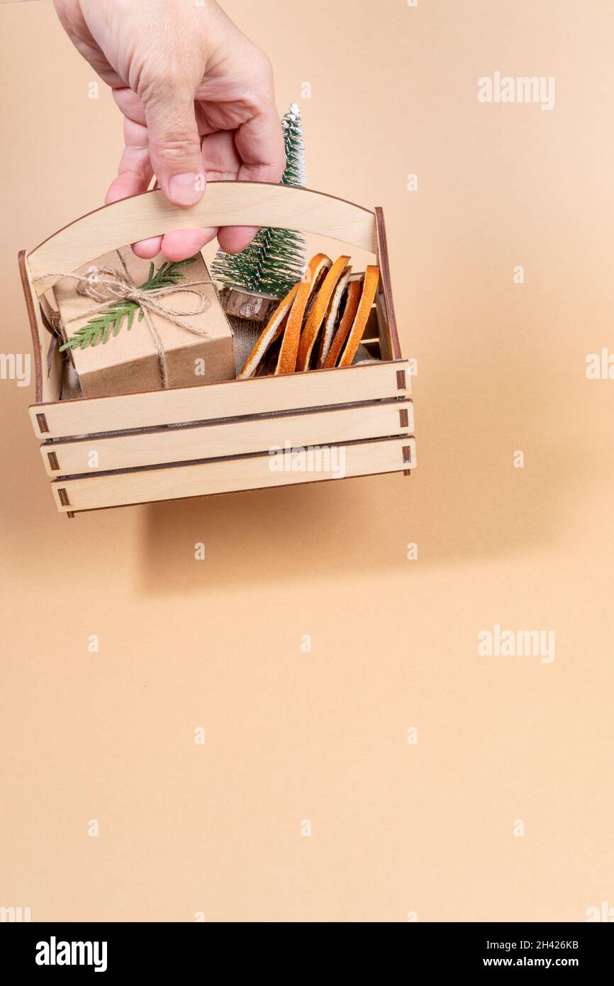 Woman hand holding wooden box with Christmas - decorations decorative ...