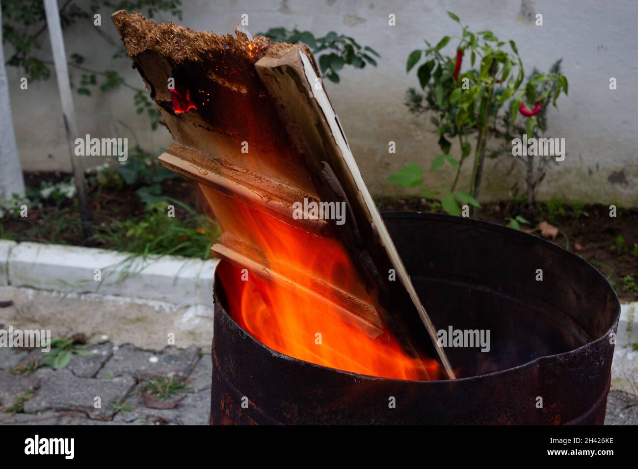 Huge burning wooden pieces in a barrel. Sparkling fire Stock Photo - Alamy