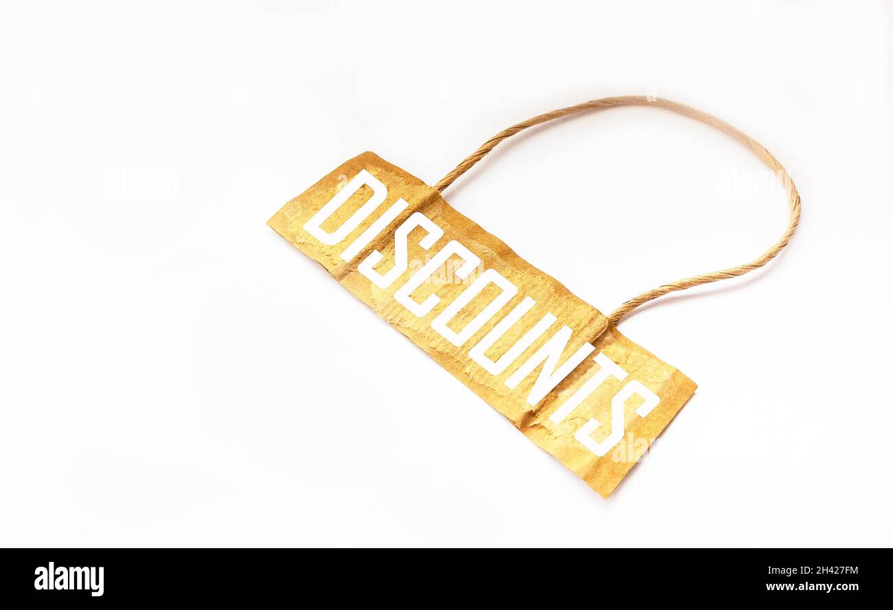 Discount, word written on brown label against white background. Write ...