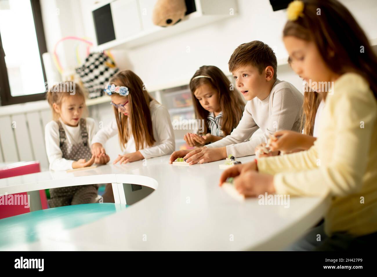 Group of little kids playing with preschool wooden educational toys ...
