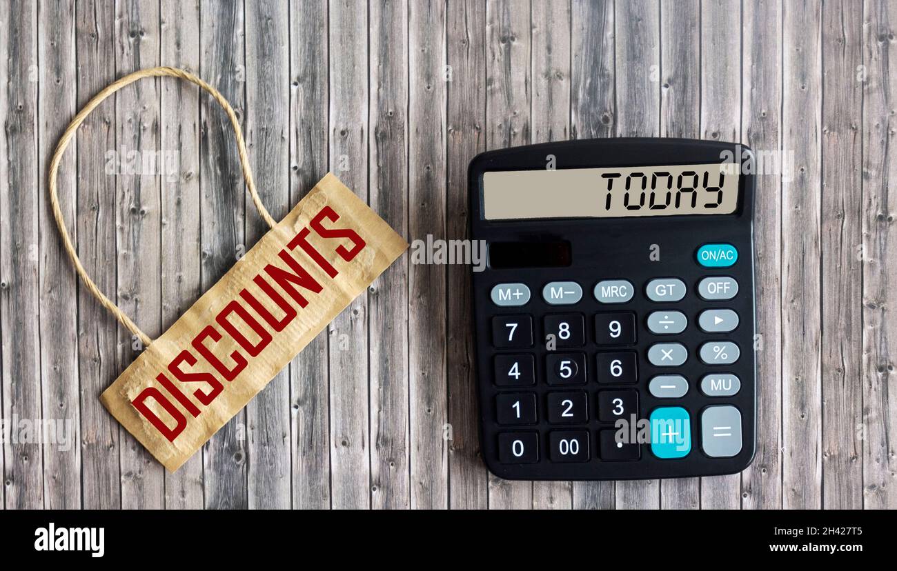 The text TODAY is written on a calculator and the word DISCOUNTS is ...