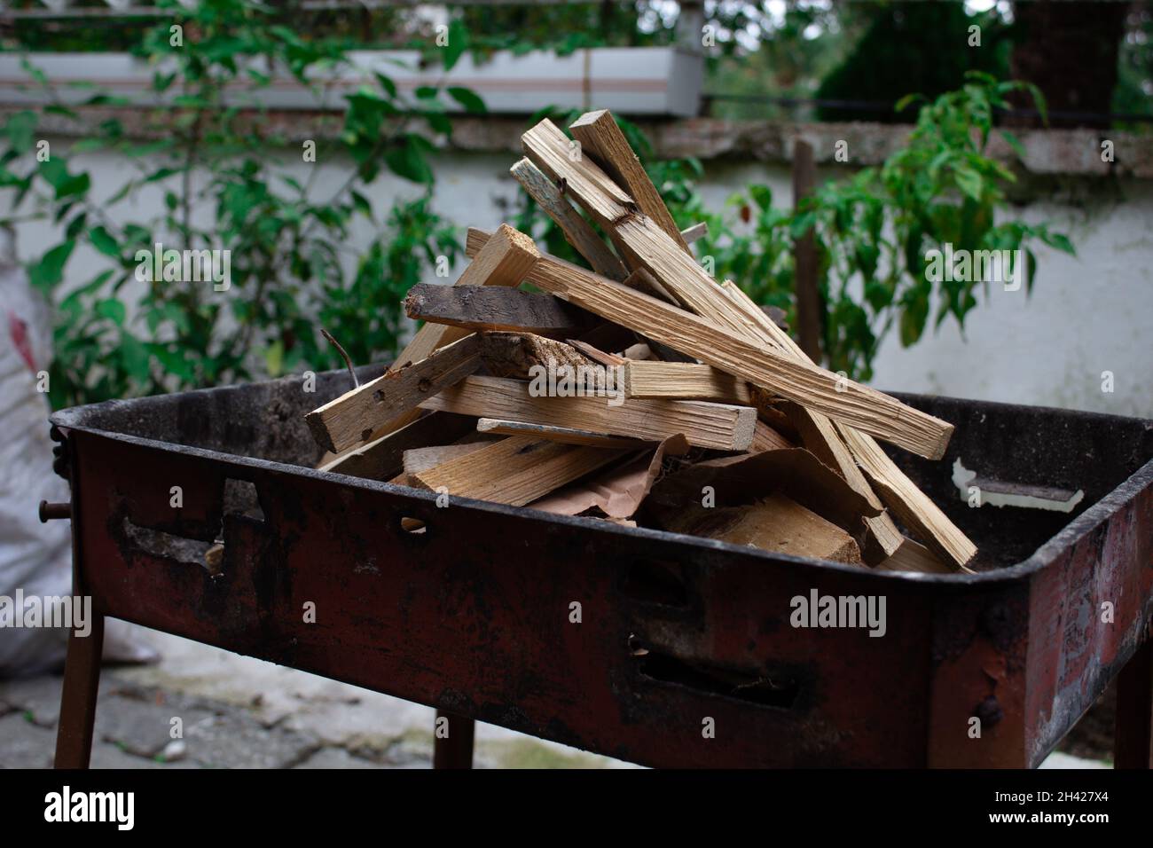 Stacked wooden pieces in a grill burning in orange fire. Preparation ...