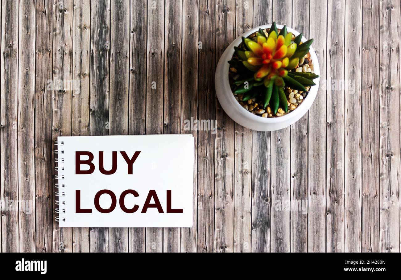buy local text on notepad and wooden background- shopping concept Stock ...