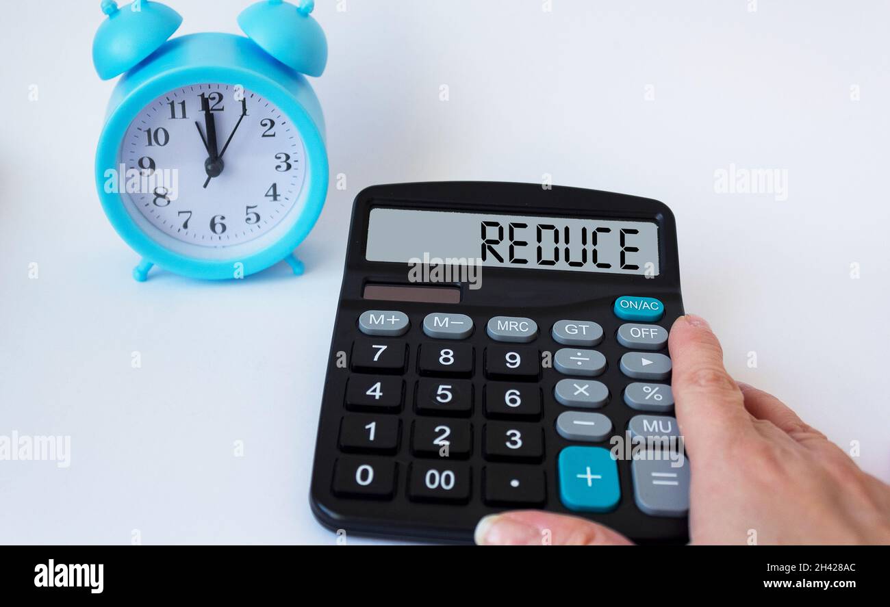 REDUCE, the text is written on the display of the calculator by a woman ...