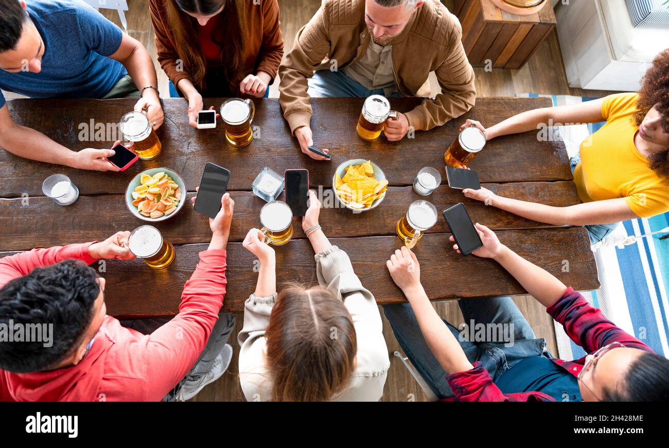 Top view of multiracial friends hands using smartphones - Men and girls ...