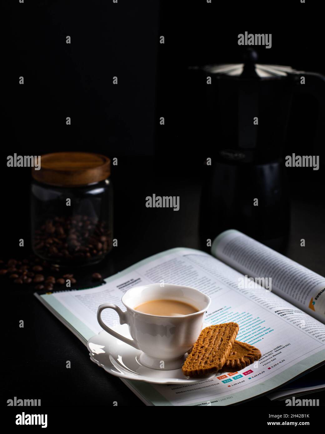 Reading a magazine with a little cup of coffee Stock Photo - Alamy