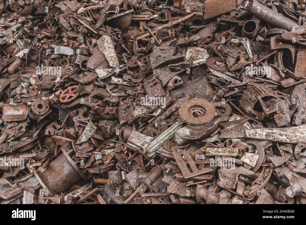 A bunch of old dirty rusty metal and iron waste to recycle in a ...