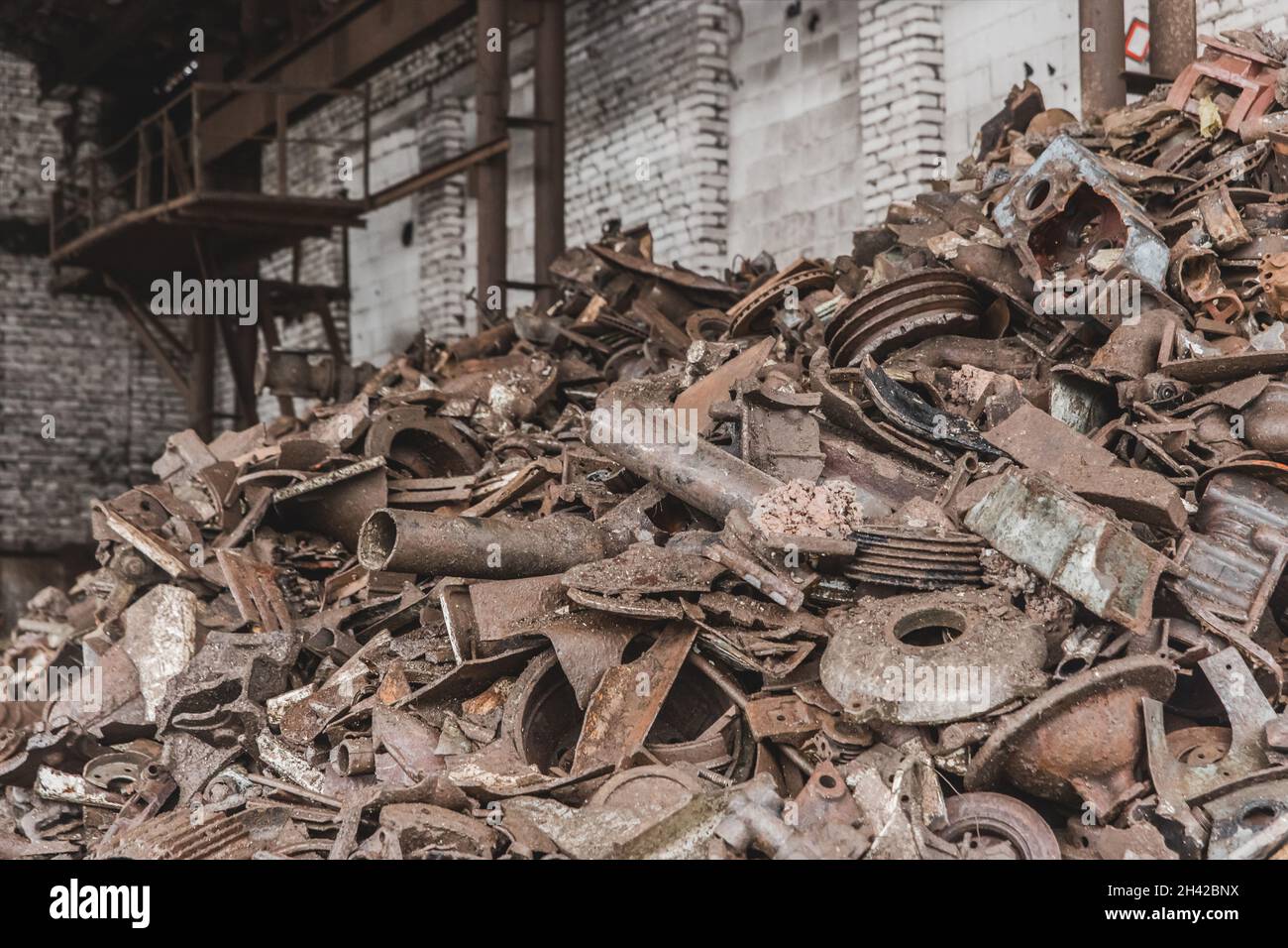 A bunch of old dirty rusty metal and iron waste to recycle in a ...