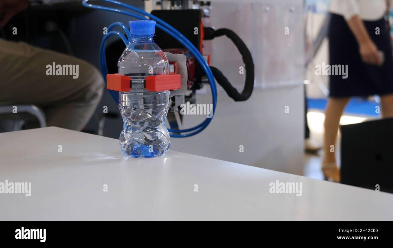 Robot hand is holding a bottle of water. Media. Technological progress ...