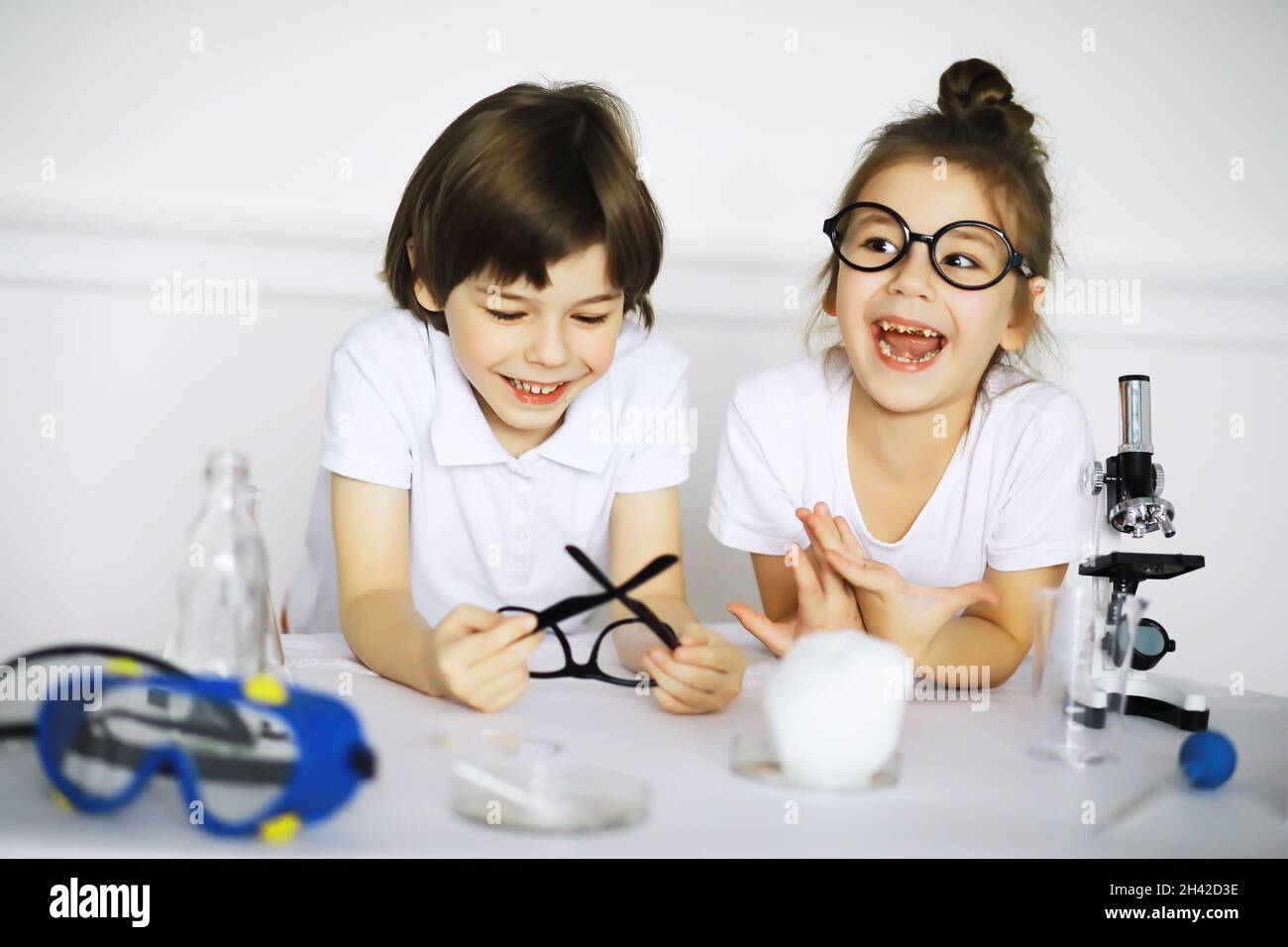 Two cute children at chemistry lesson making experiments isolated on ...