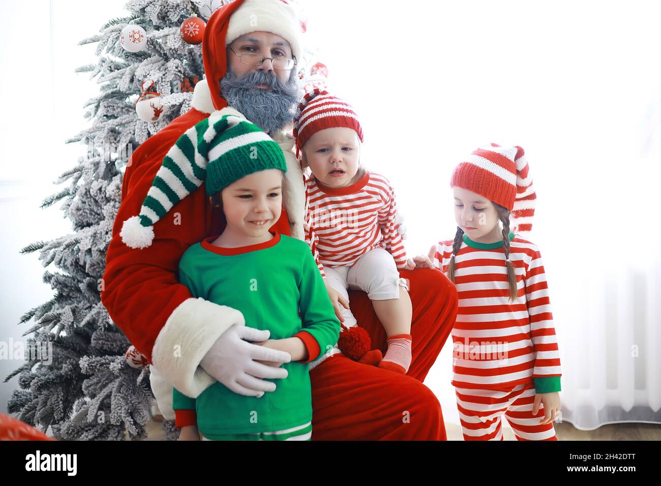 Santa Claus's helpers.Cute children in christmas elf costumes in a room ...