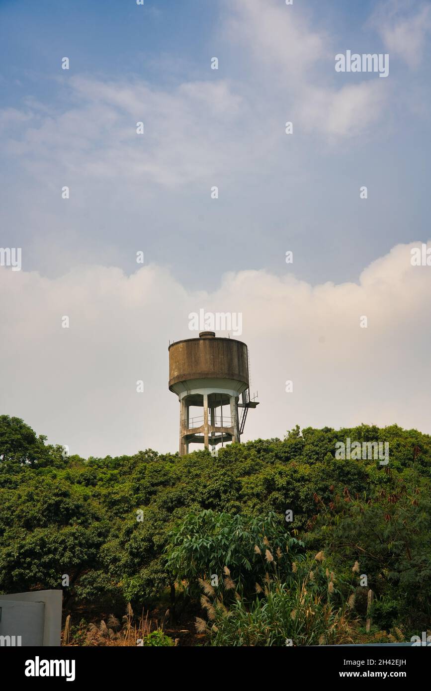 A vertical shot of a water tower near the forest Stock Photo - Alamy