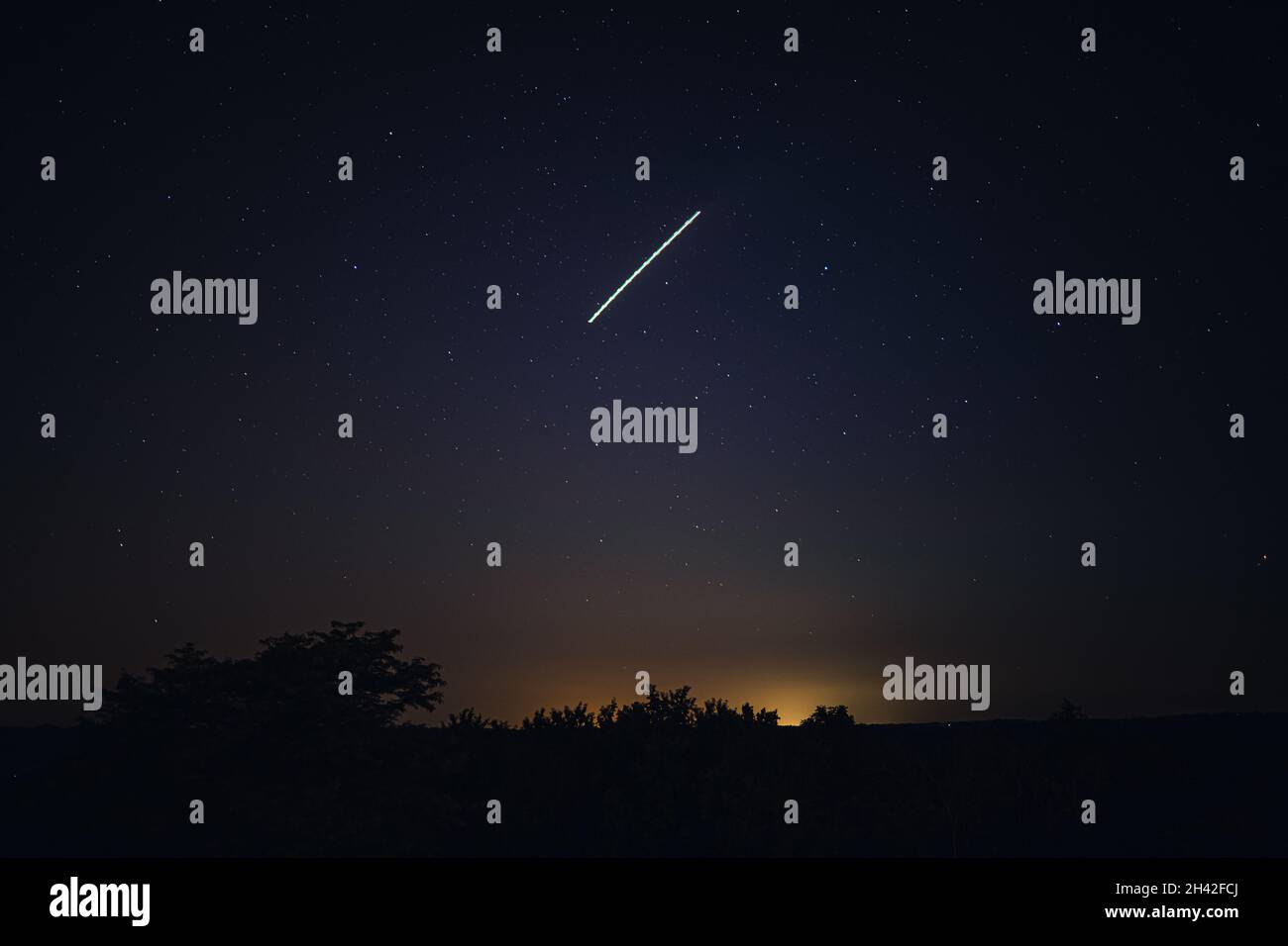 A Breathtaking scene of a fallen star fro the starry sky Stock Photo ...