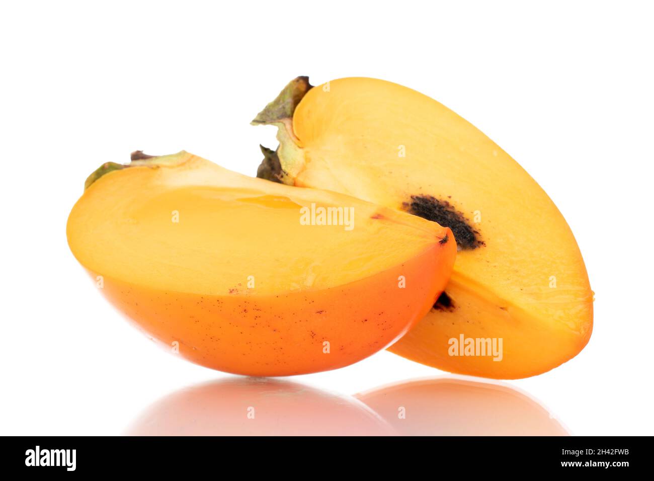 Two slices of sweet organic persimmon, close-up, isolated on white ...