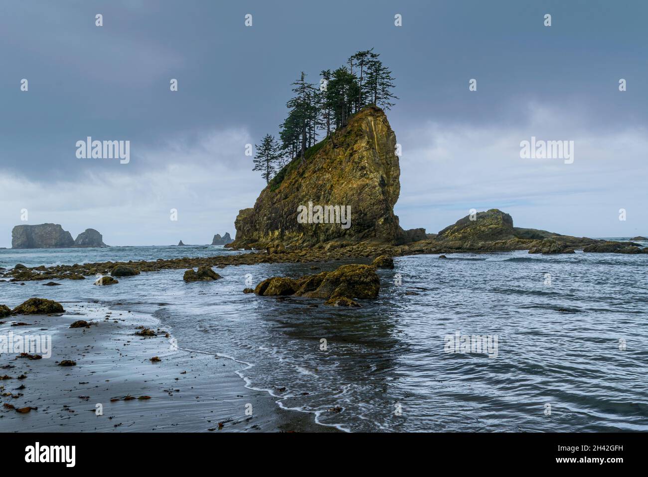Stormy sky rolling in against the rugged coastline and sea stack at ...
