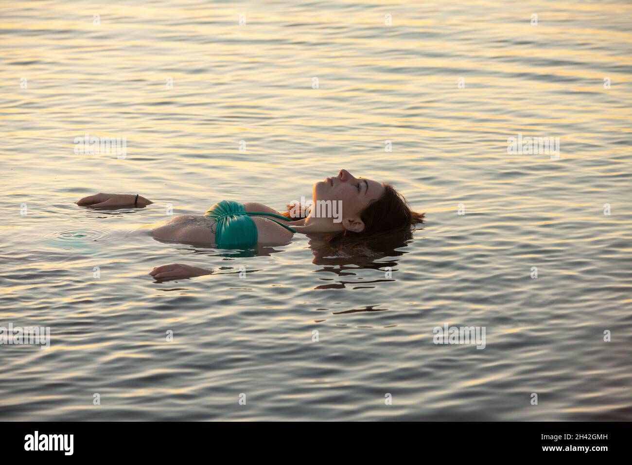 A woman lying on her back floating in cold scottish sea water Stock ...