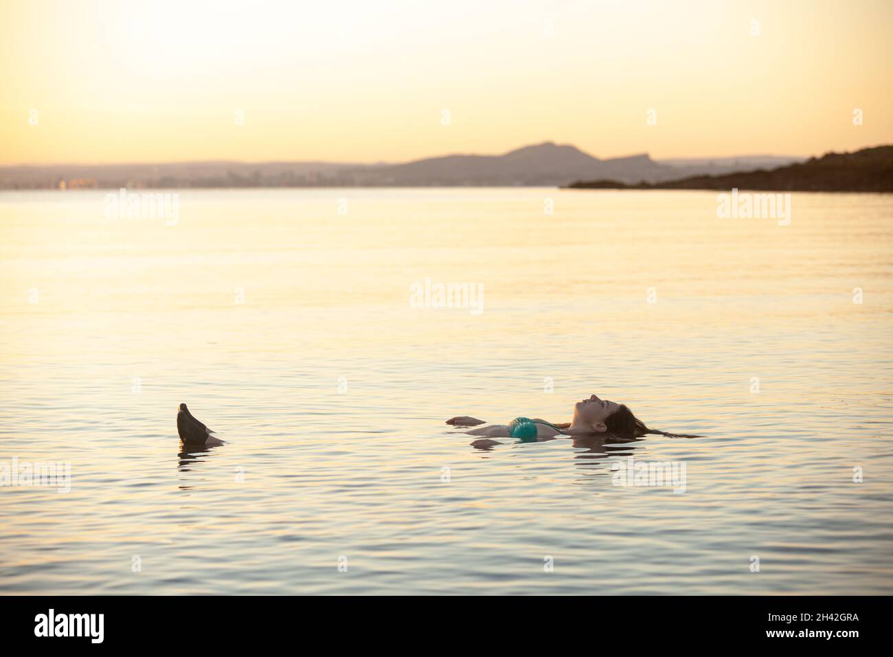 Woman floating on back in water hi-res stock photography and images - Alamy
