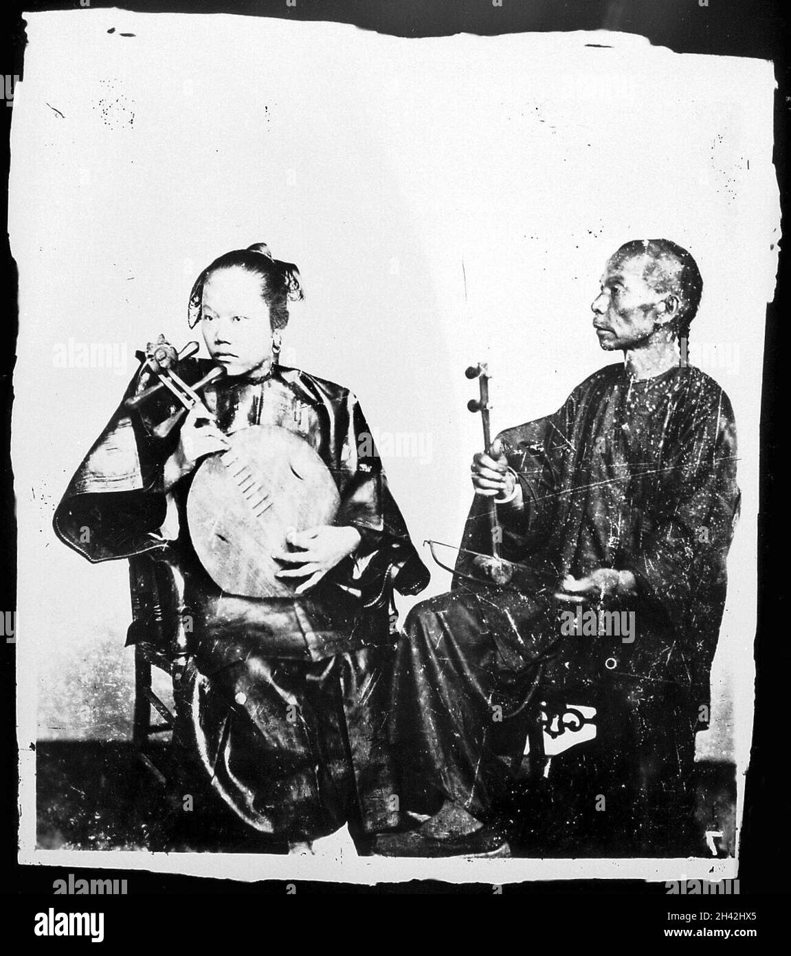 Two Chinese musicians with their instruments, Canton, Kwangtung ...