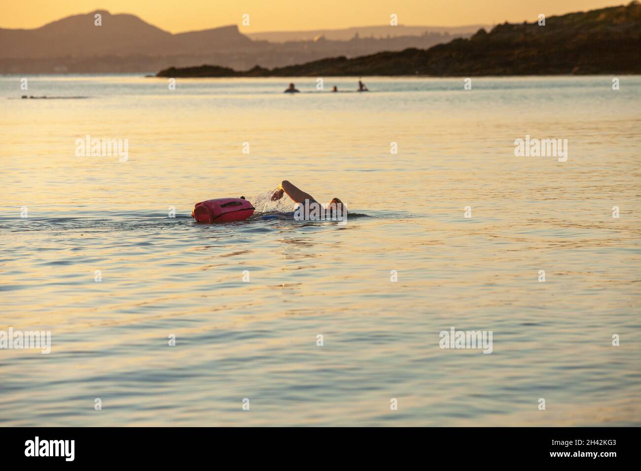 A woman swimming in the Firth of Forth on a cold October morning Stock ...