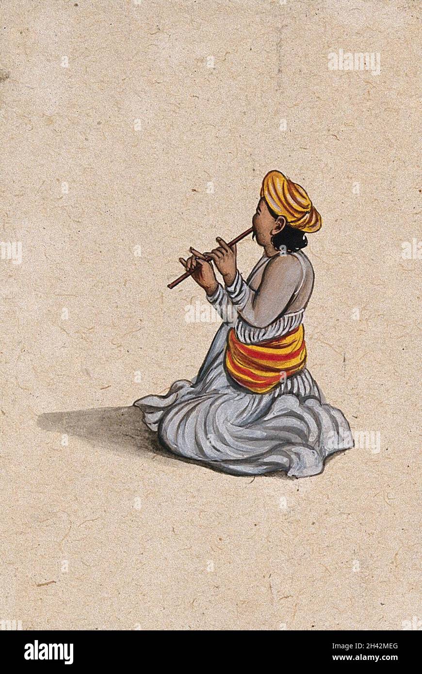 An Indian musician playing a bansuri (flute). Gouache painting by an ...