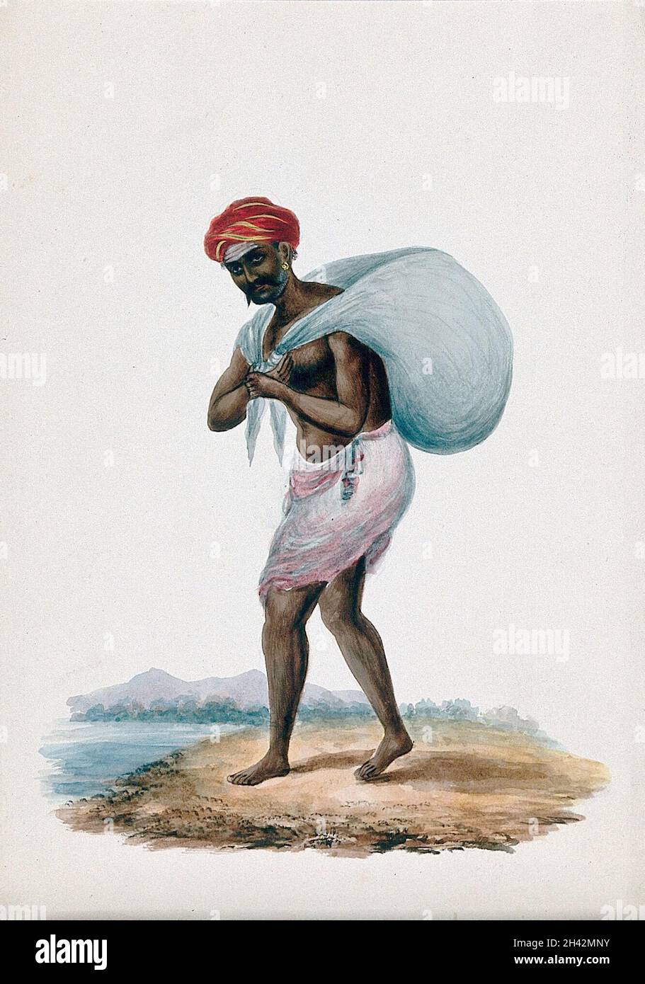 A dhobi (laundry man) talking a load of clothes to the river to clean ...