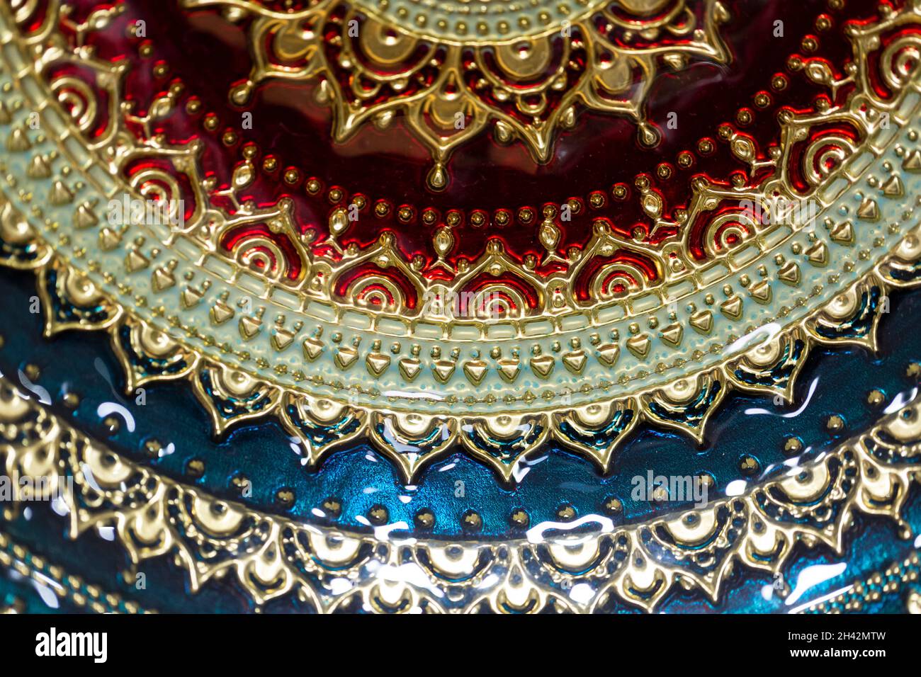 Decorative ceramic plate with blue, red and golden colors, painted ...