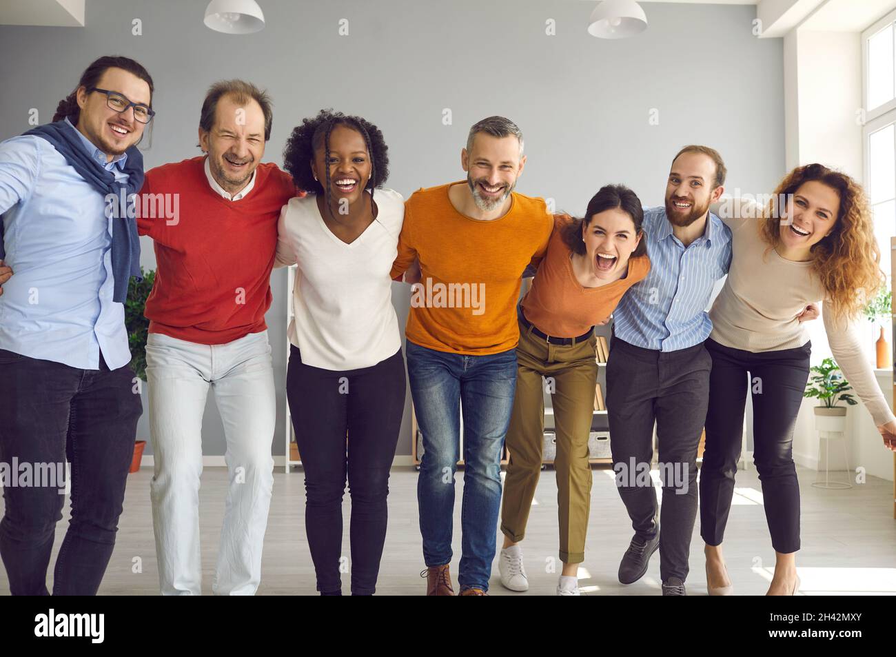 Team of happy diverse business people and friends huddling, laughing ...