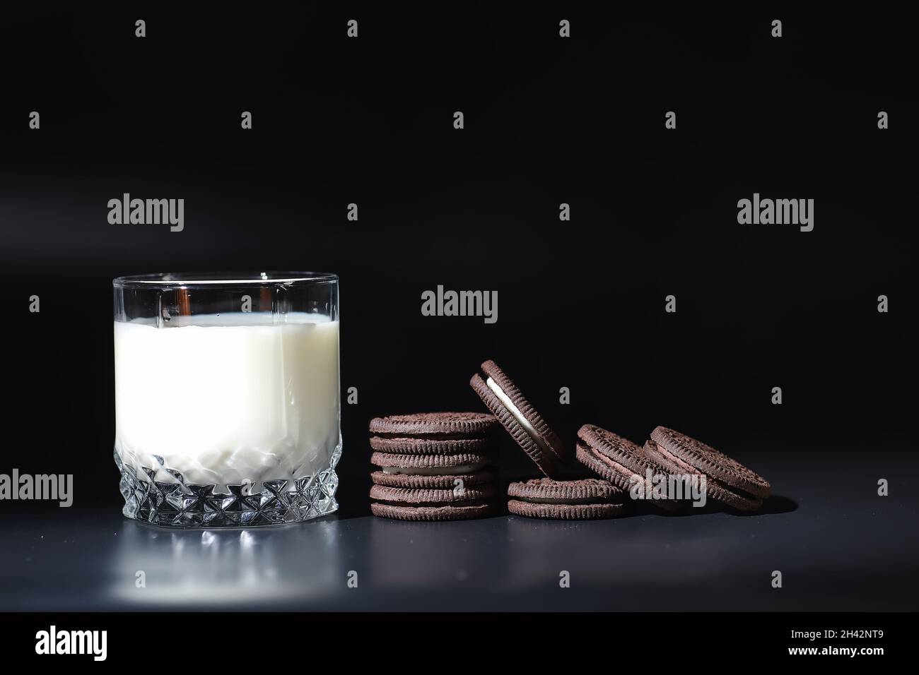 Milk drink in glass. Farm milk and cookies. Delicious snack with cow's ...