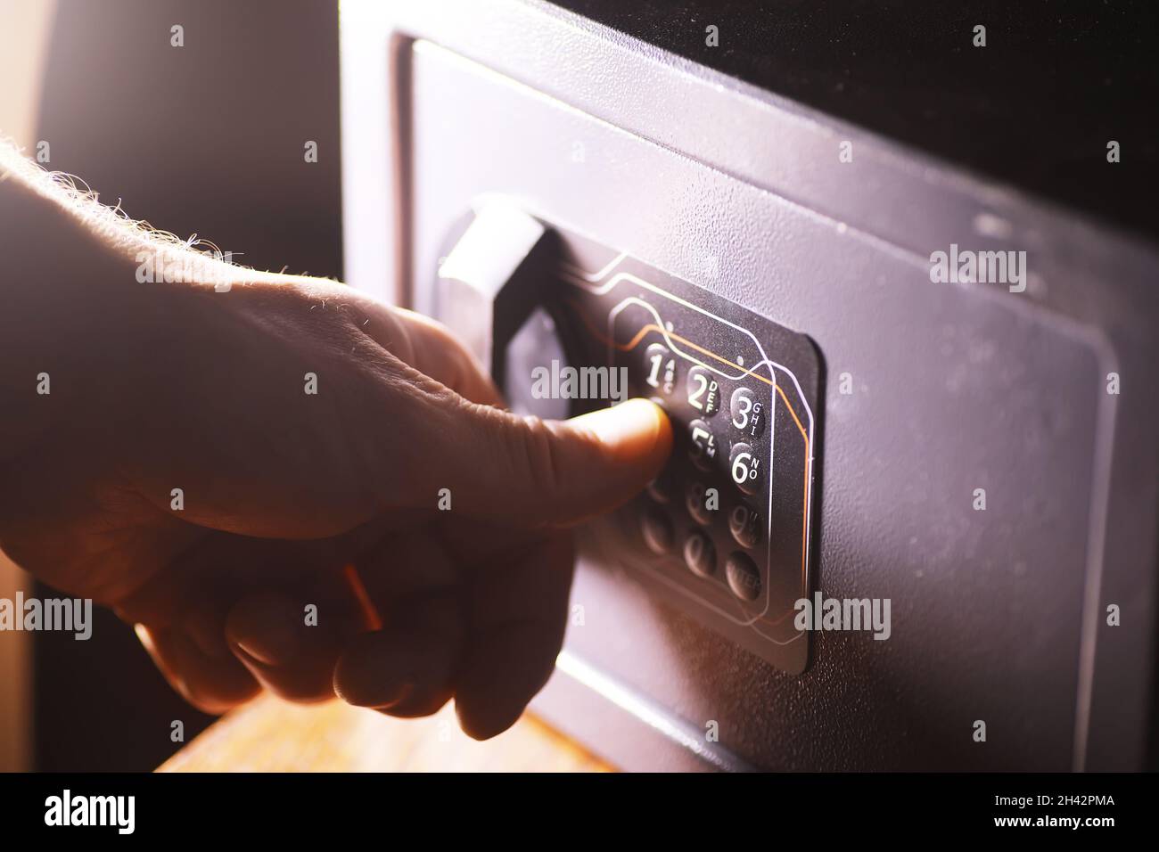 Steel safe with money. Hand putting password in the safety money box in ...