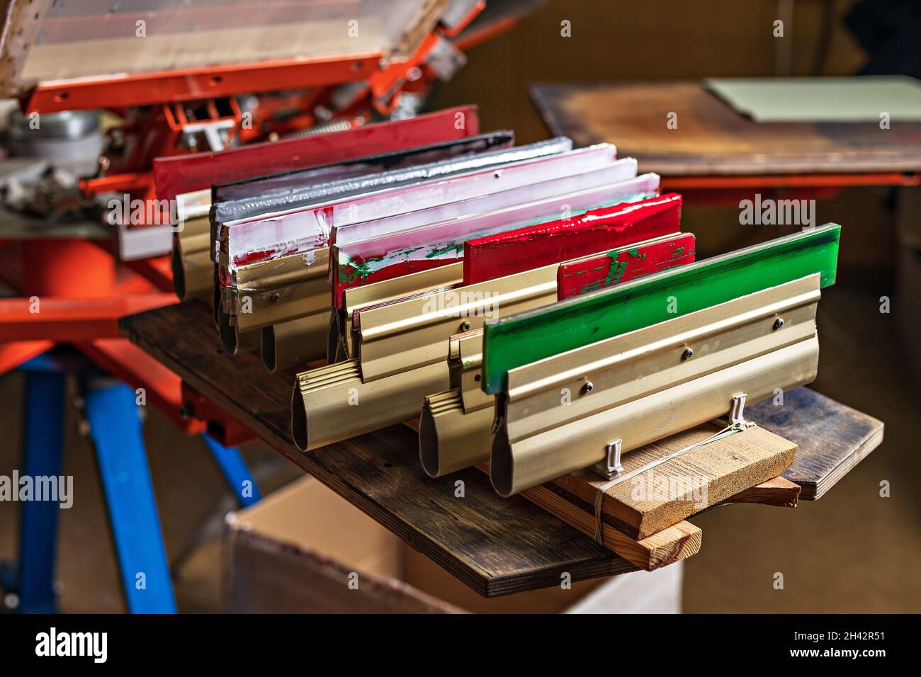 silk screen printing. serigraphy production. squeegees on wooden shelve ...