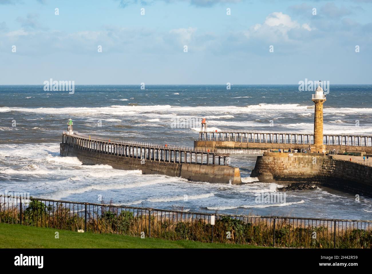 Rough seas and Whitby harbour captured from the cliff tops above in ...