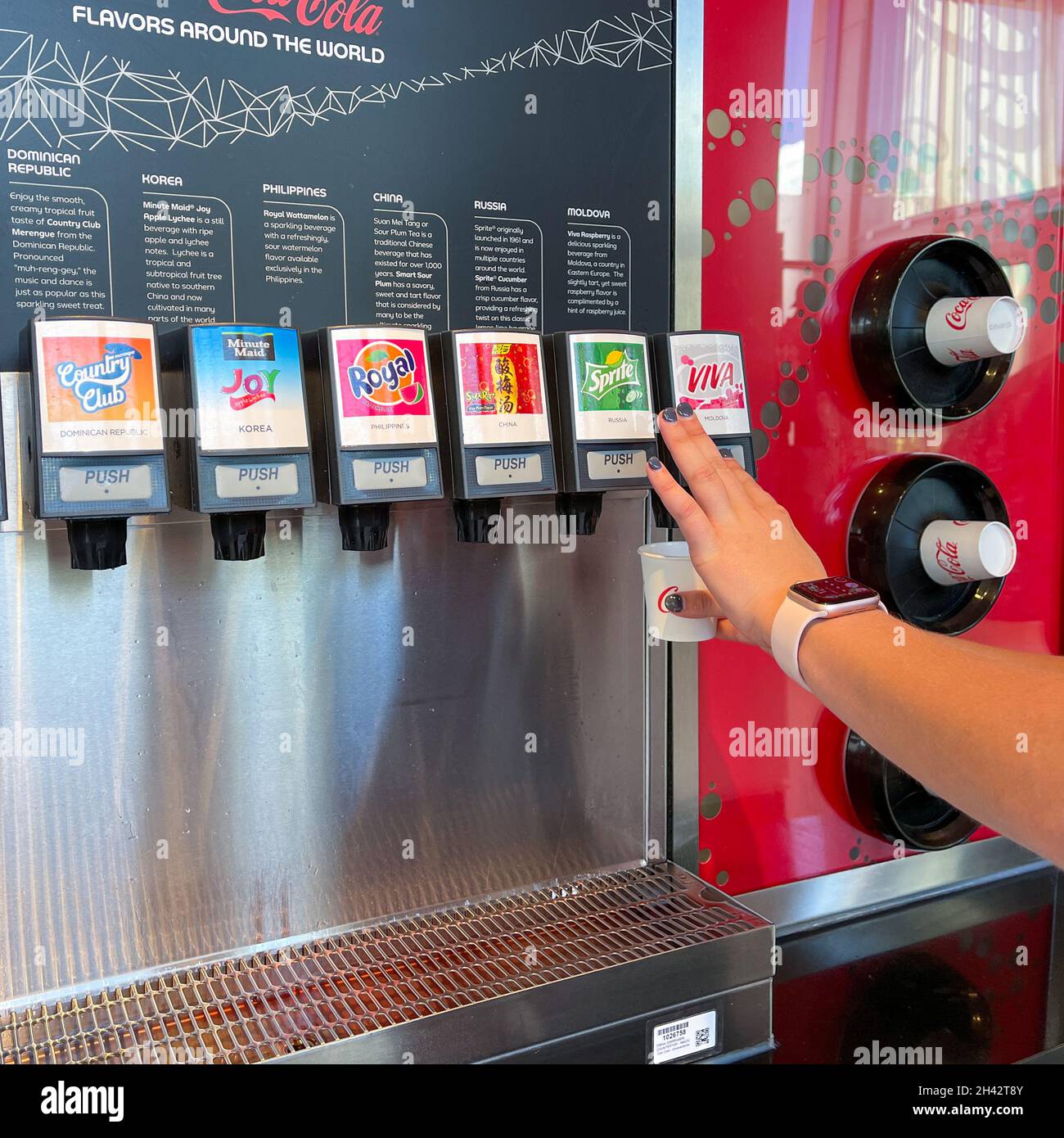 Orlando, FL USA - October 9, 2021: A person pouring soda from a sample ...