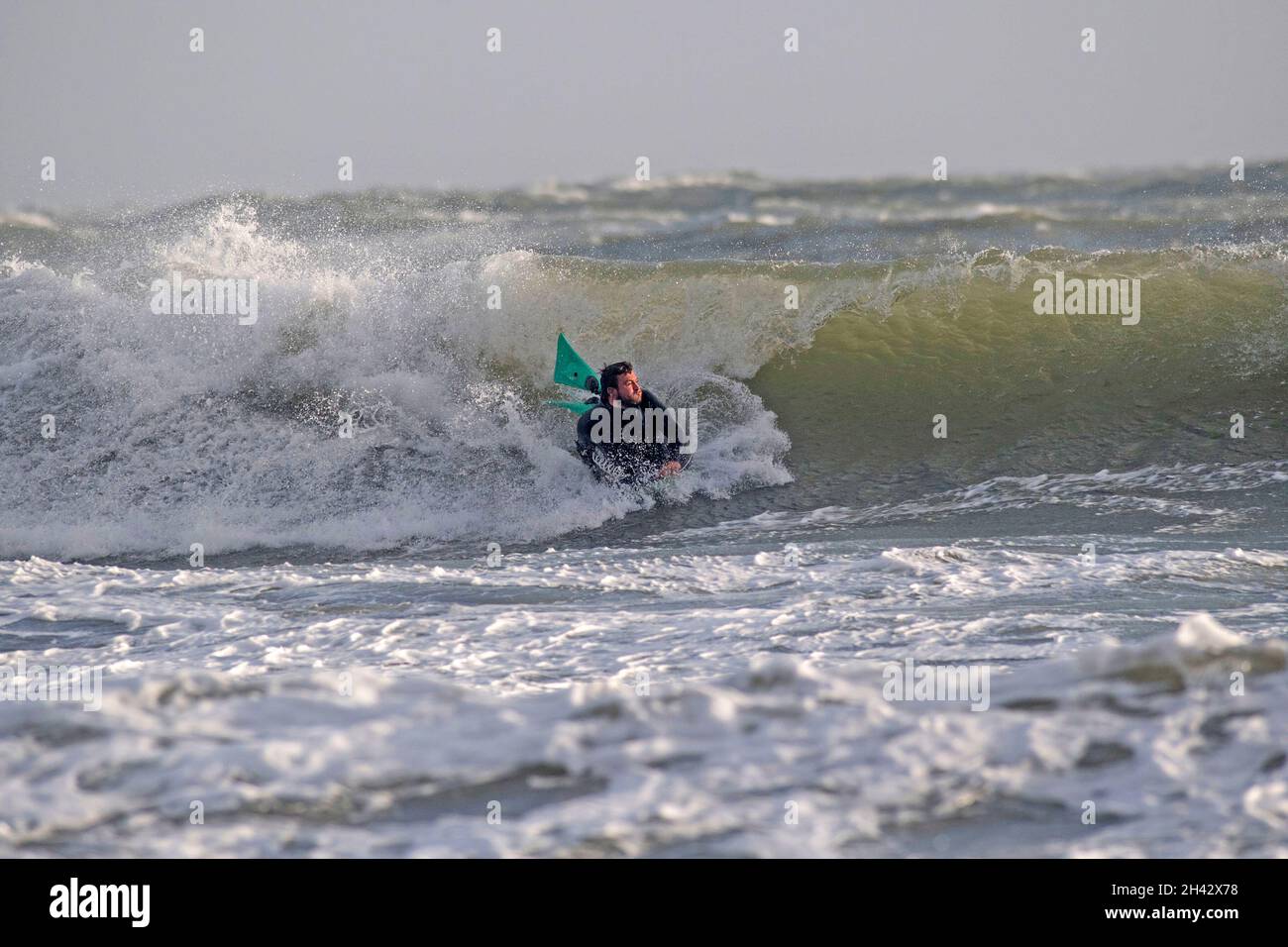 Swansea, UK. 31st Oct, 2021. Surfers enjoying the waves at Langland Bay ...