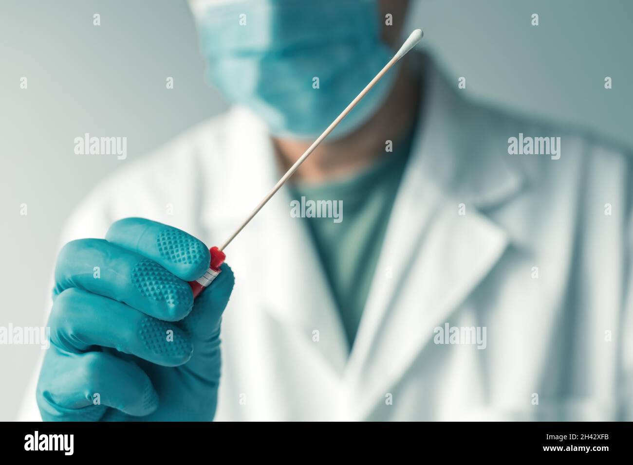 Medical professional with sample swab in clinic laboratory during Covid ...