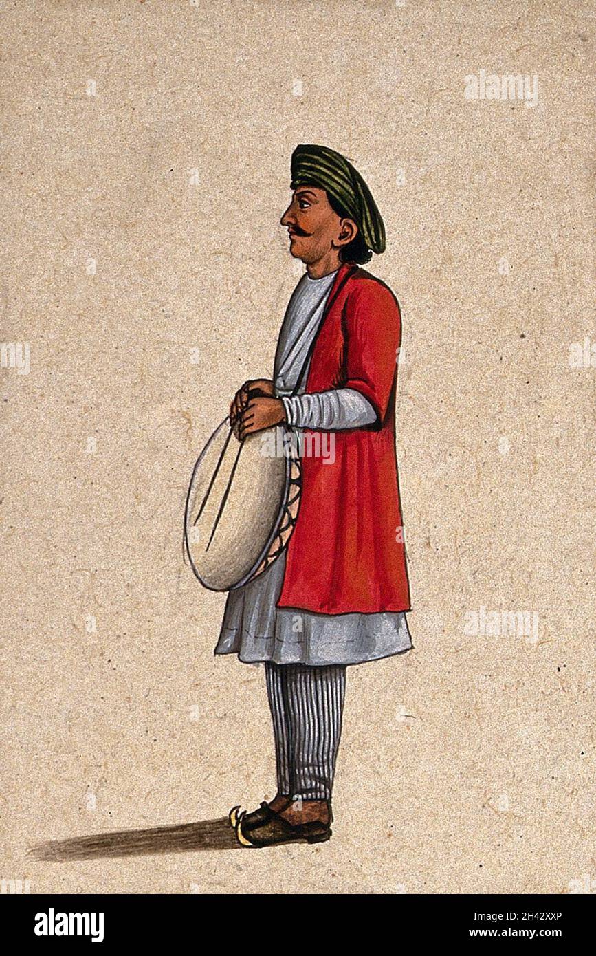 A musician playing an Indian percussion instrument, similar to the dhap ...