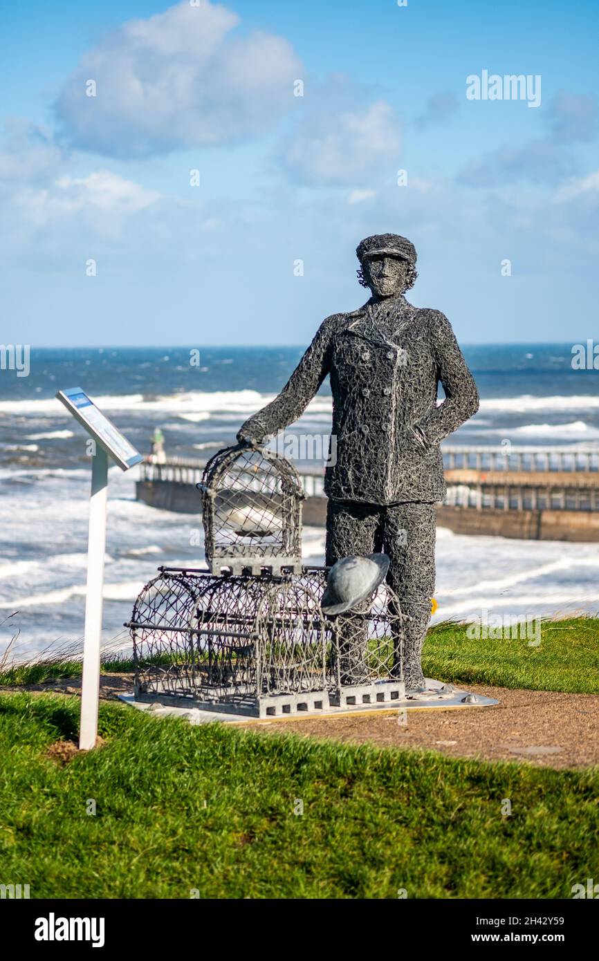 The Statue of the Skipper Dora on West Cliff in the coastal town of ...