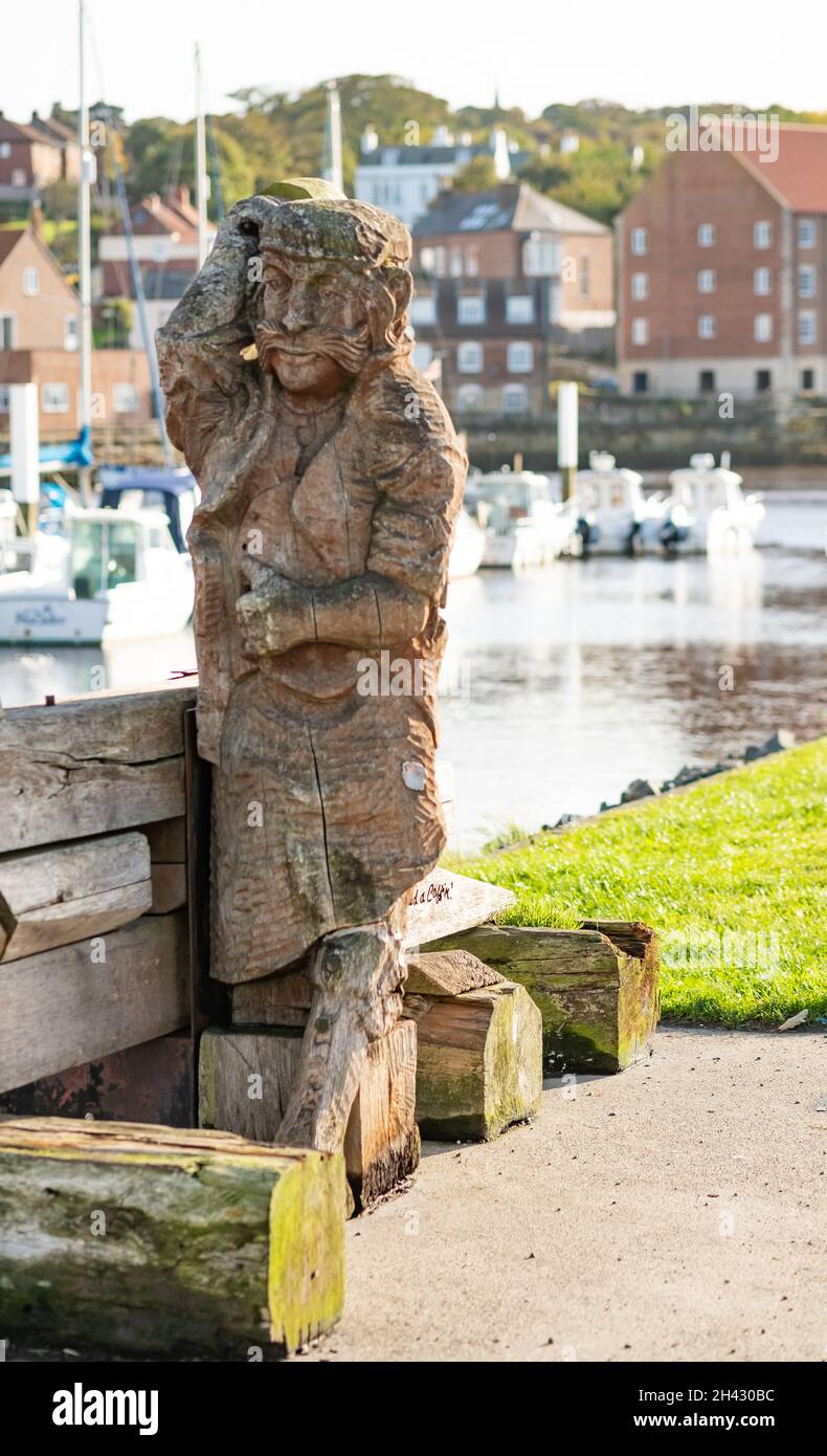 Wooden sculpture on the water’s edge in Whitby Marina in North ...