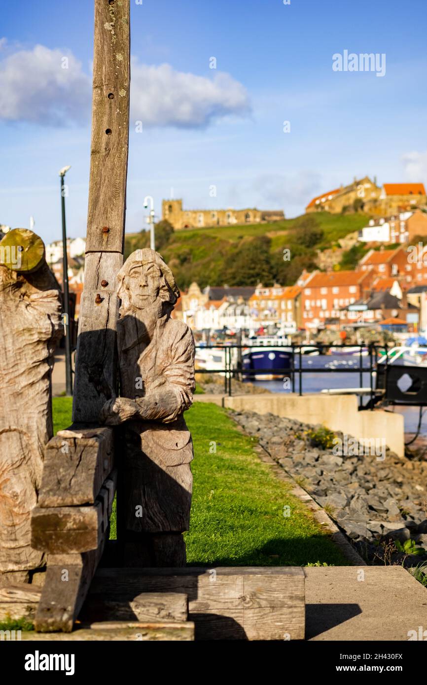 Wooden sculpture on the water’s edge in Whitby Marina in North ...