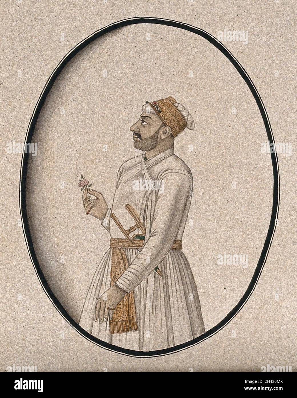 A Mughal courtier carrying a dagger and holding a flower. Watercolour ...