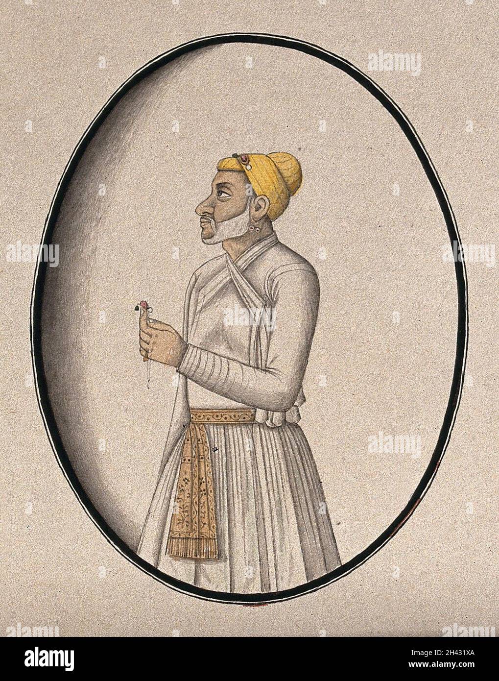 A Mughal courtier with a yellow turban holds an ornament ...