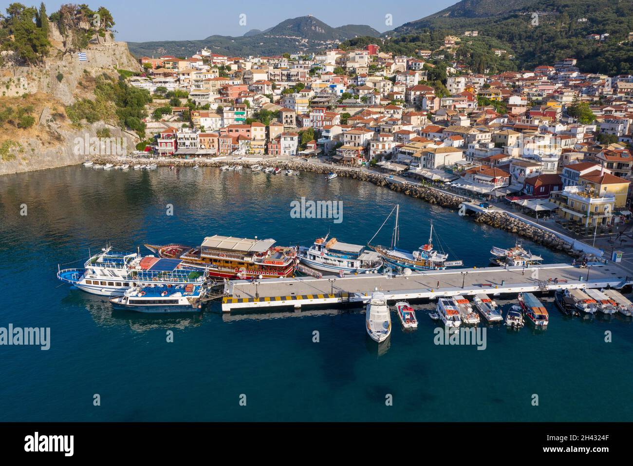 Aerial shot of port town of Parga and moored boats in West Greece ...